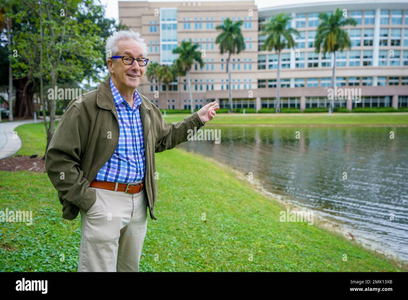 Image of a education professor pointing at a building on campus Stock ...