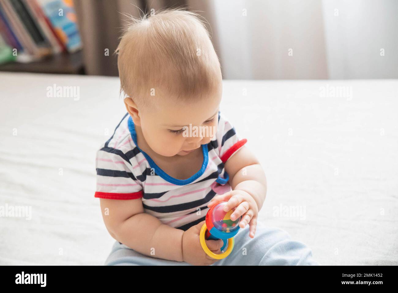 adorable baby played with a toy to develop fine motor skills Stock ...