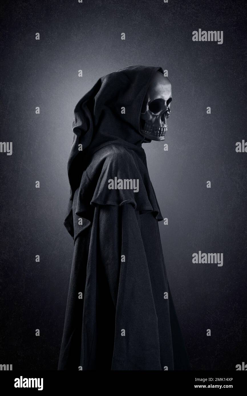 Grim reaper over dark misty background Stock Photo - Alamy