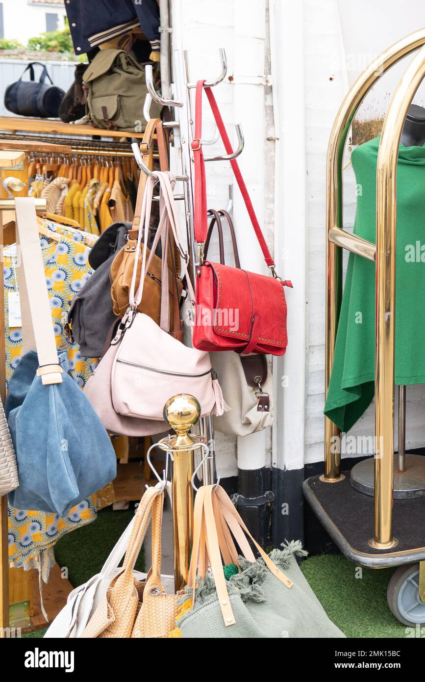 many woman purse bags vibrant colors hanging on display in shop street ...