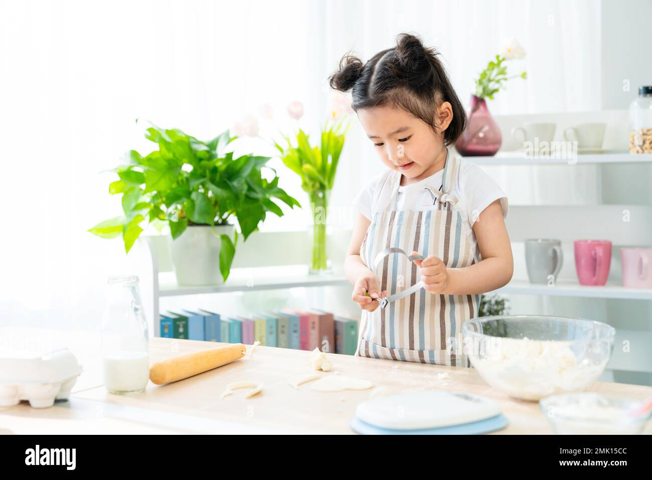 Happy little girl cooking at home Stock Photo - Alamy