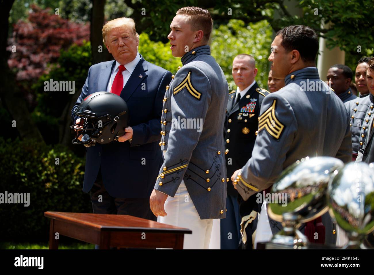 President Donald Trump looks on as Army linebacker Cole Christiansen ...