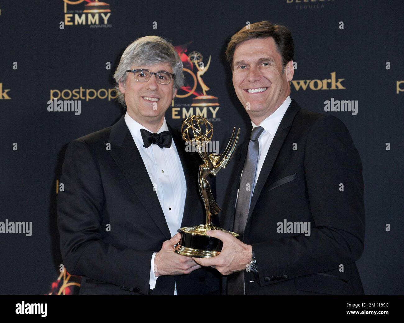 Mo Rocca, left, and Lee Cowan pose in the press room with the award for ...