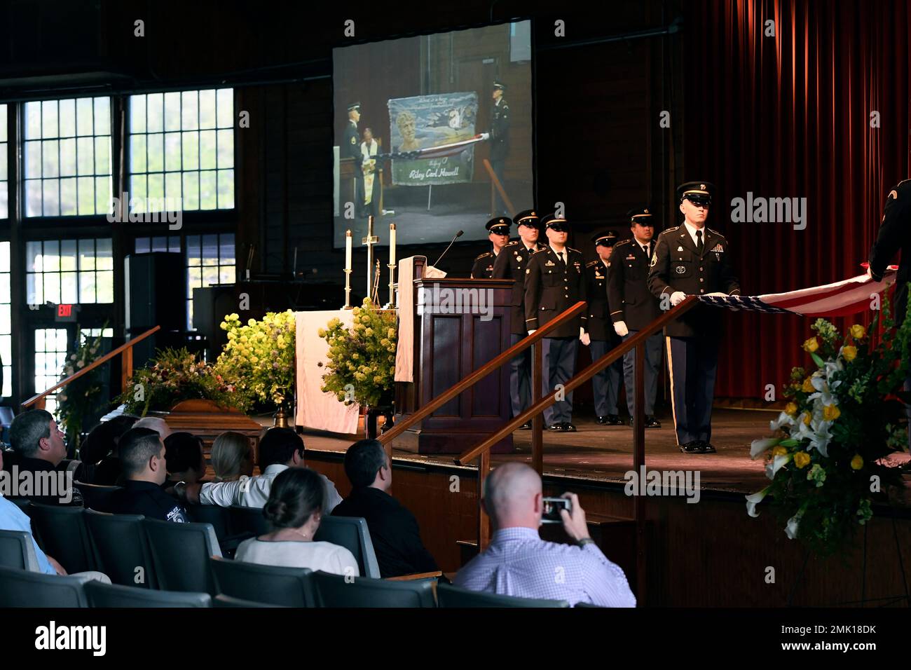 A military honor guard folds a flag for Riley Howell during his ...