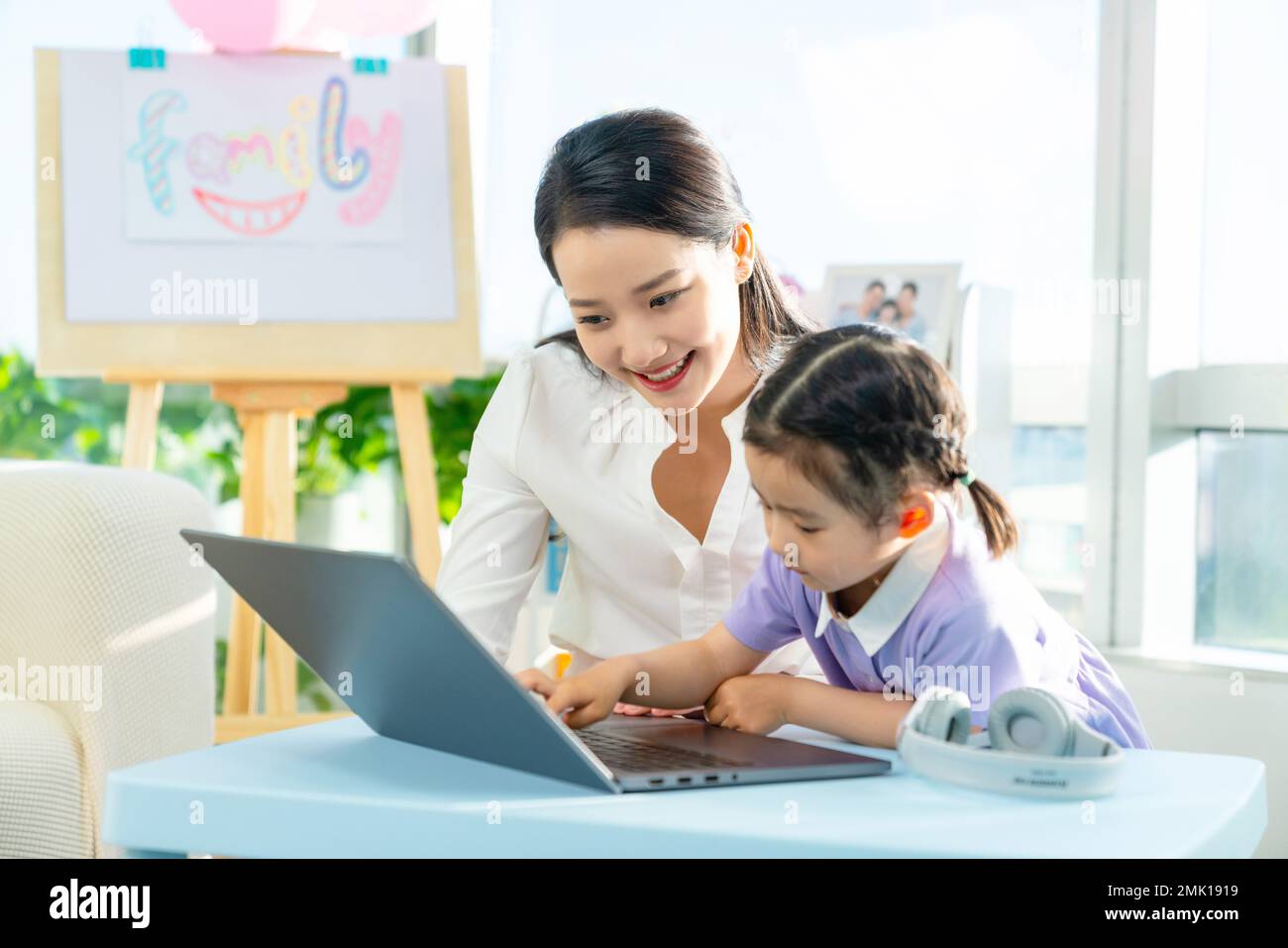Teacher with two students and computer hi-res stock photography and ...