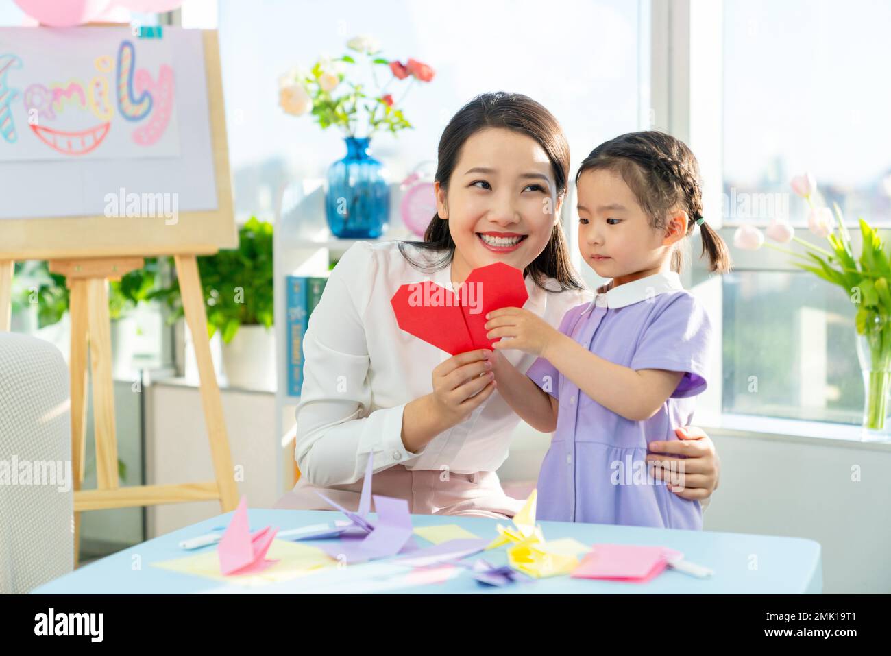 The teacher with little girl origami Stock Photo - Alamy