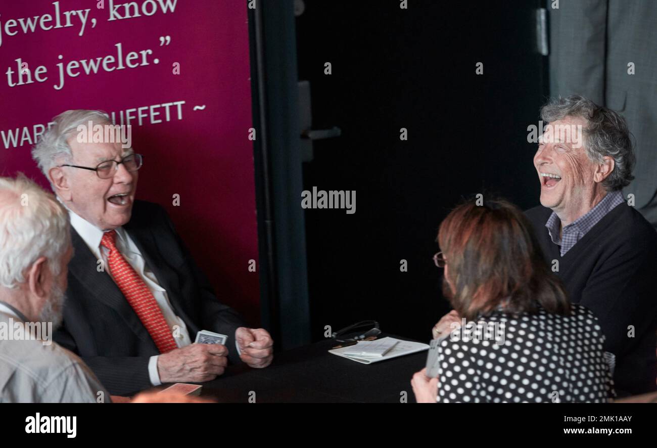 Warren Buffett, Chairman and CEO of Berkshire Hathaway, left, jokes ...