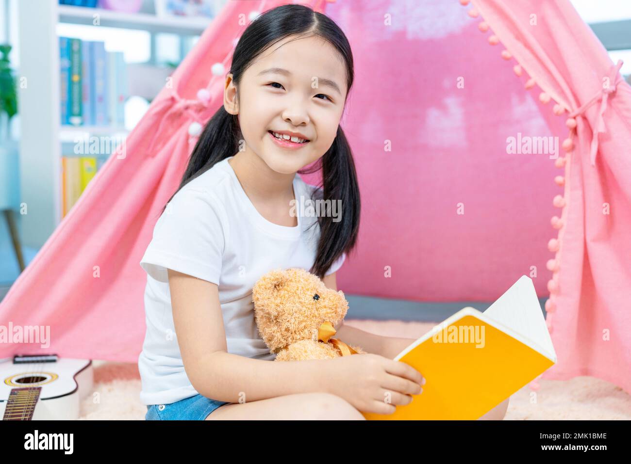 The little girl was reading a book Stock Photo - Alamy