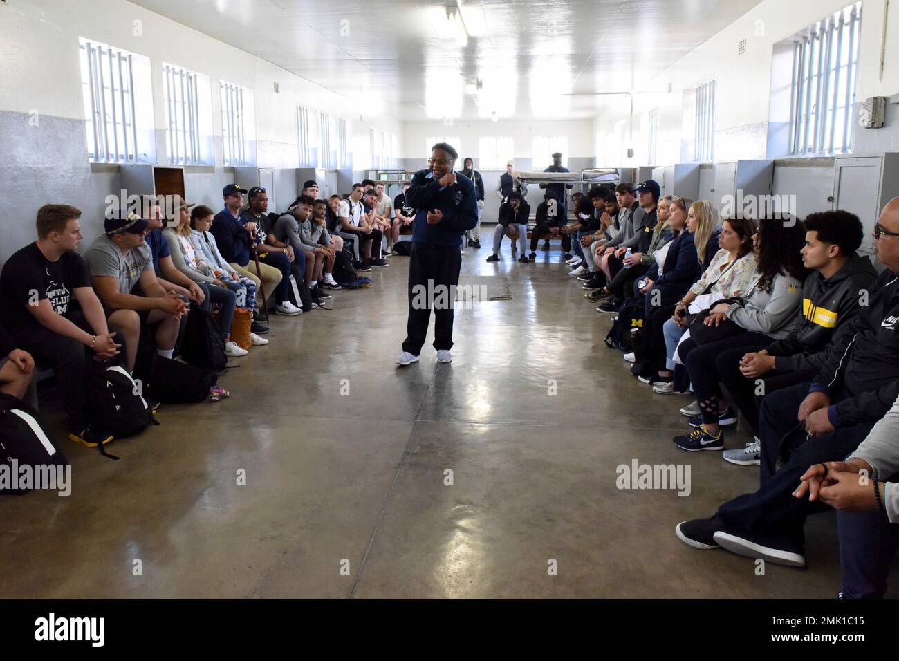 Members of the University of Michigan American Football Team listen to ...