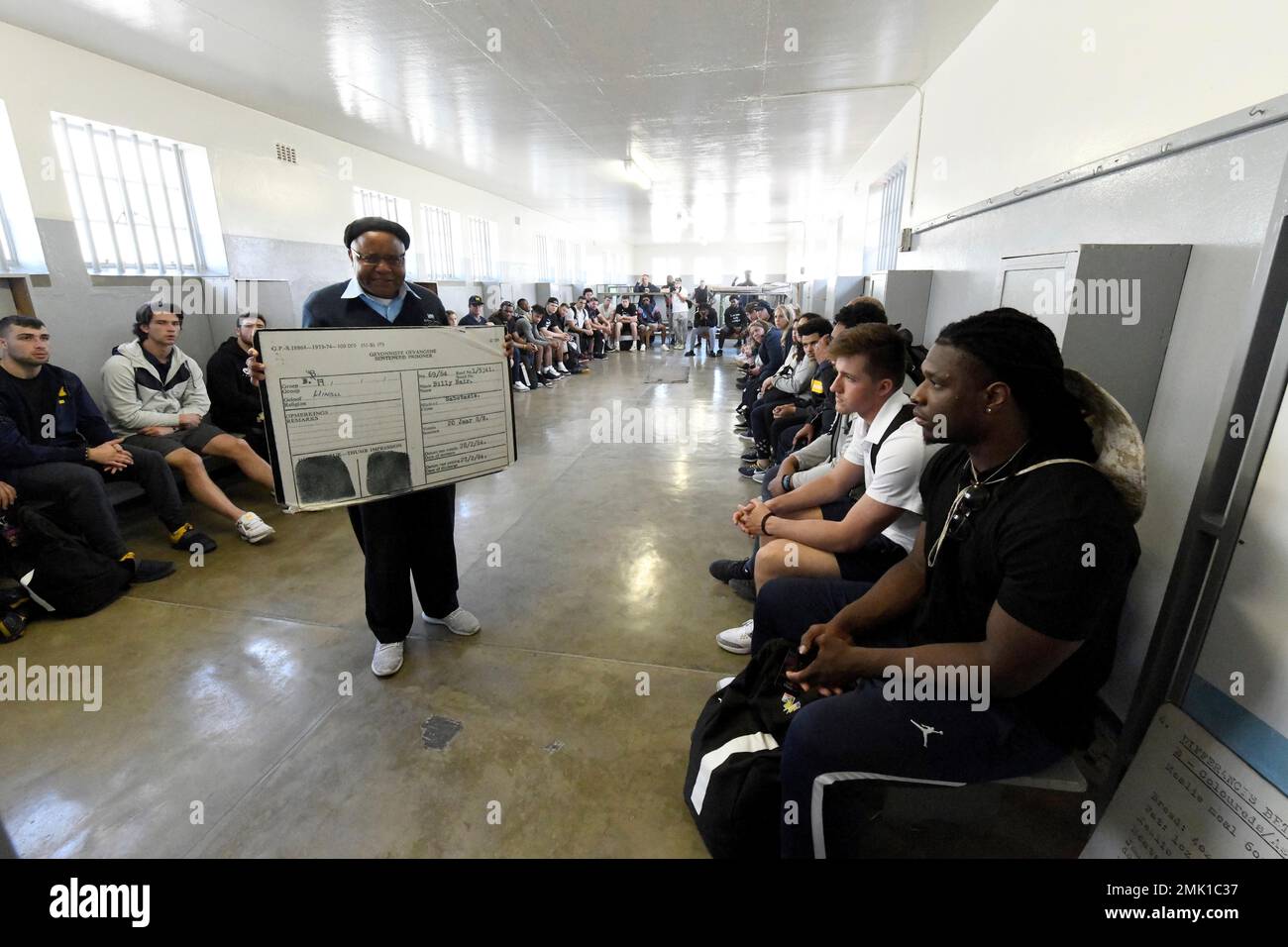 Members of the University of Michigan American Football Team listen to ...