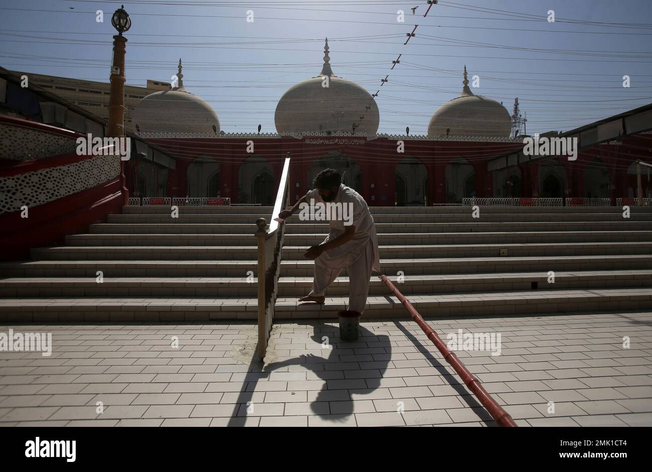 A painter gives finishing touches to a handrail of Mamon Mosque in ...