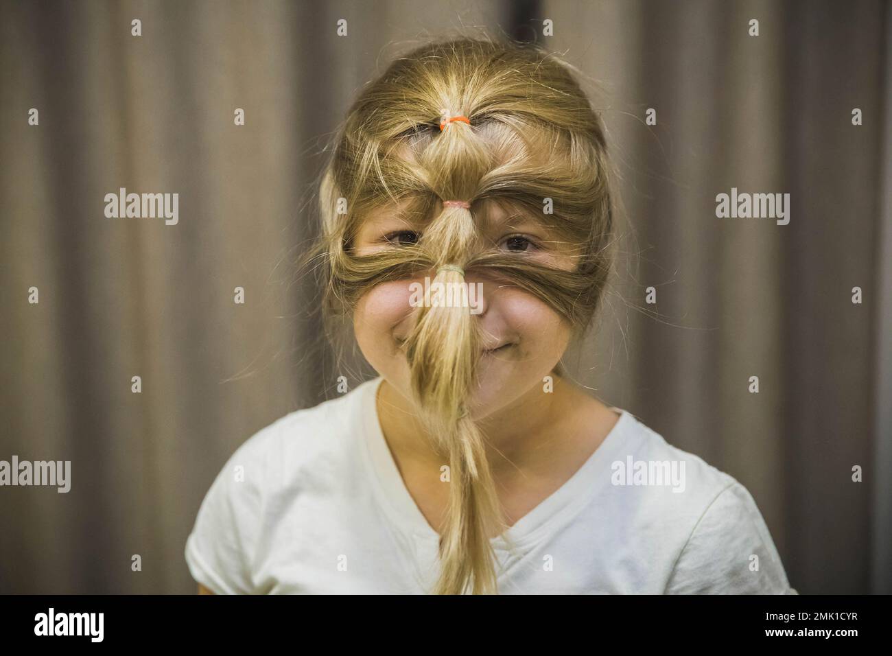 girl for fun made from hair a mask on her face Stock Photo - Alamy