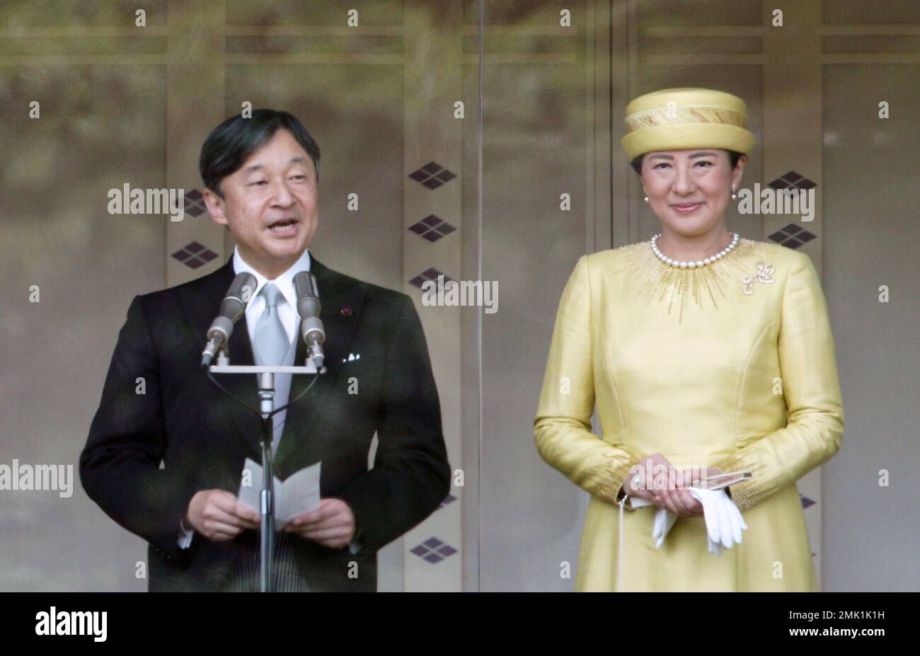 Japan's new Emperor Naruhito, left, delivers a speech, accompanied by ...