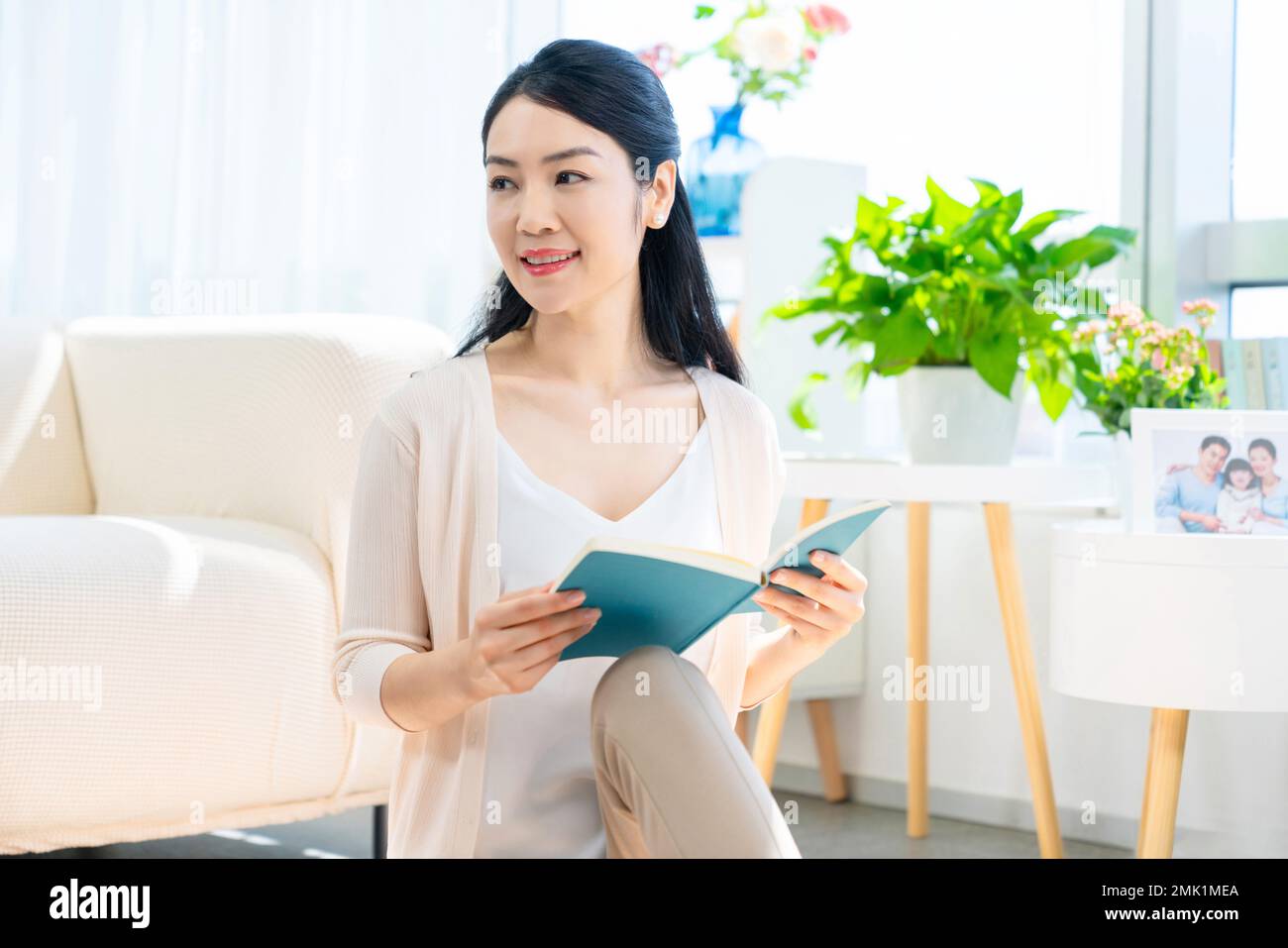 The young lady at home reading a book Stock Photo - Alamy