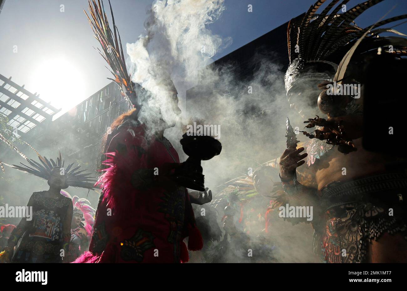Smoke rises from a smudge pot as dancers with CeAtl Tonalli, a ...