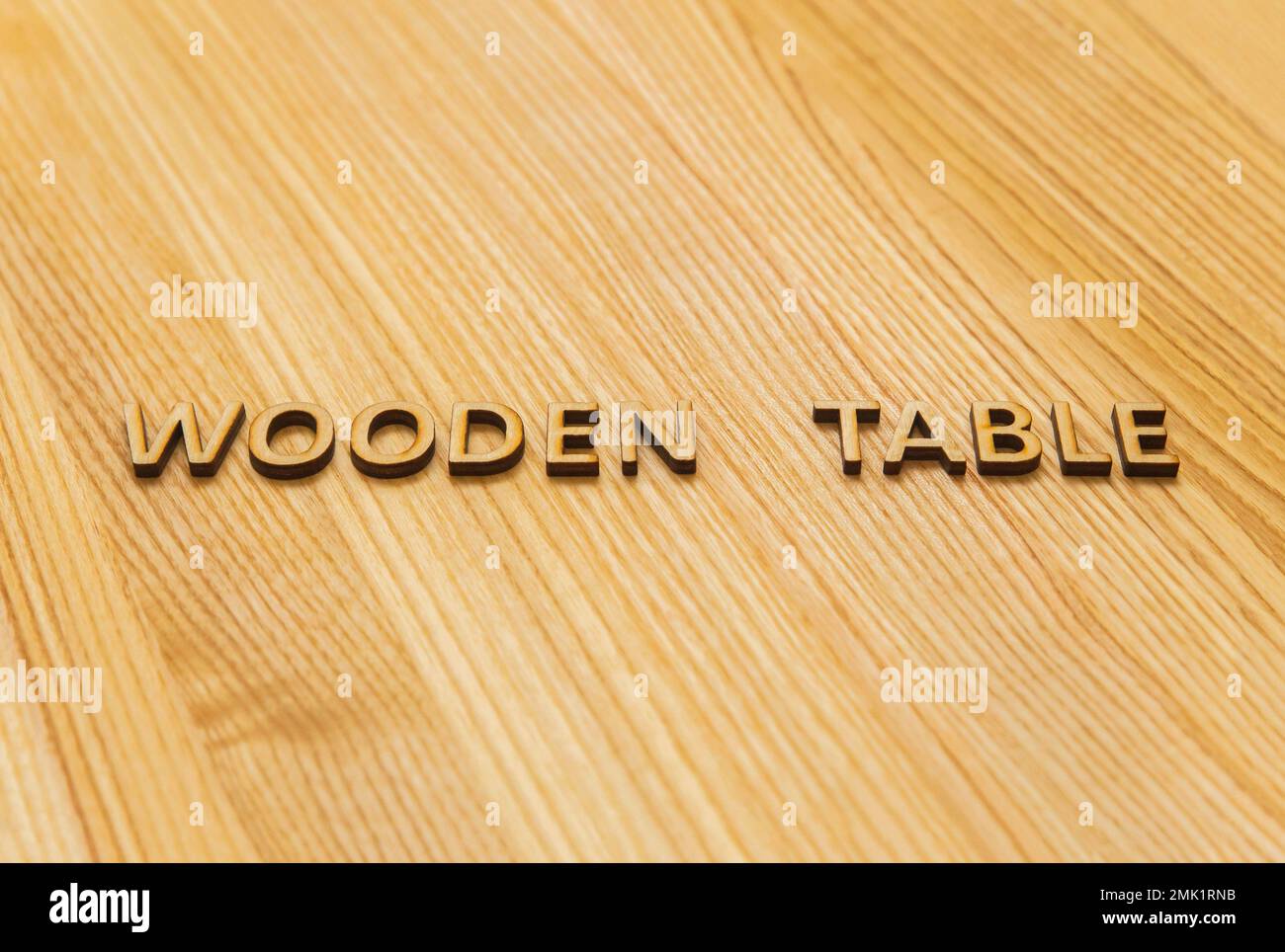 The inscription "wooden table" on the oak table top. Background Stock ...
