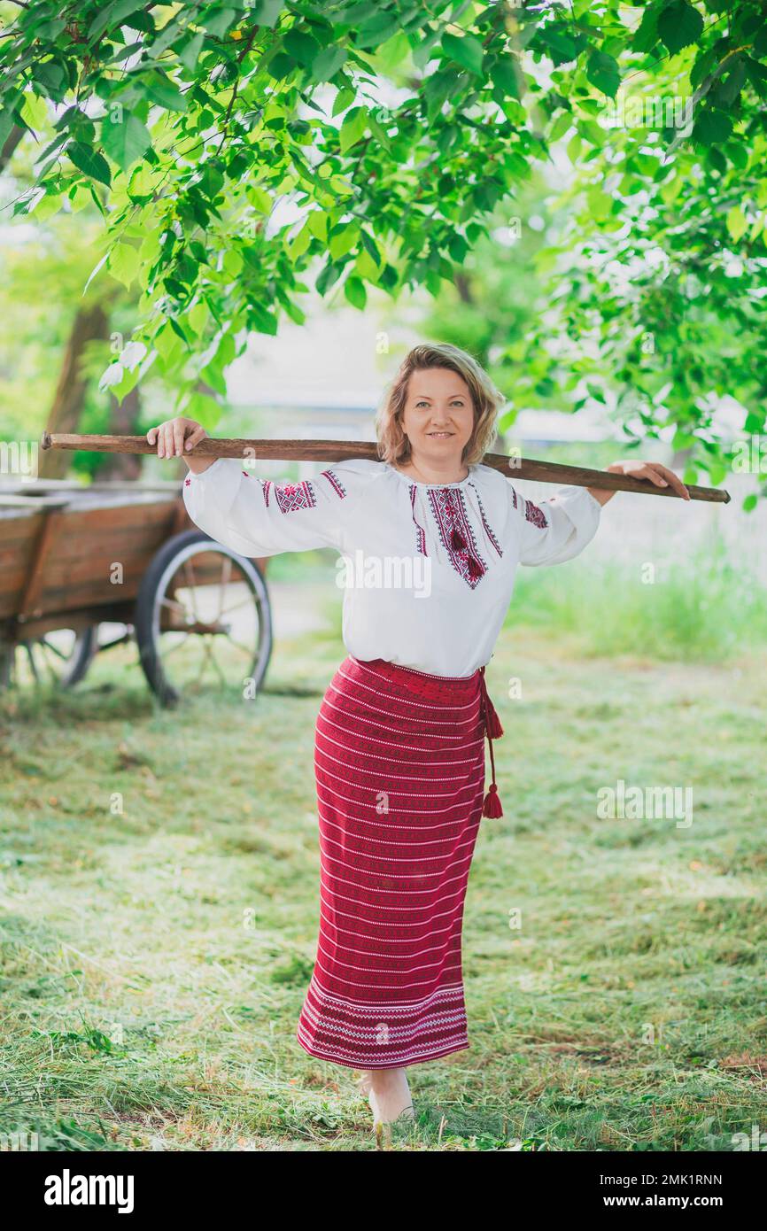 woman in embroidered clothes walks with balance beam for water Stock ...