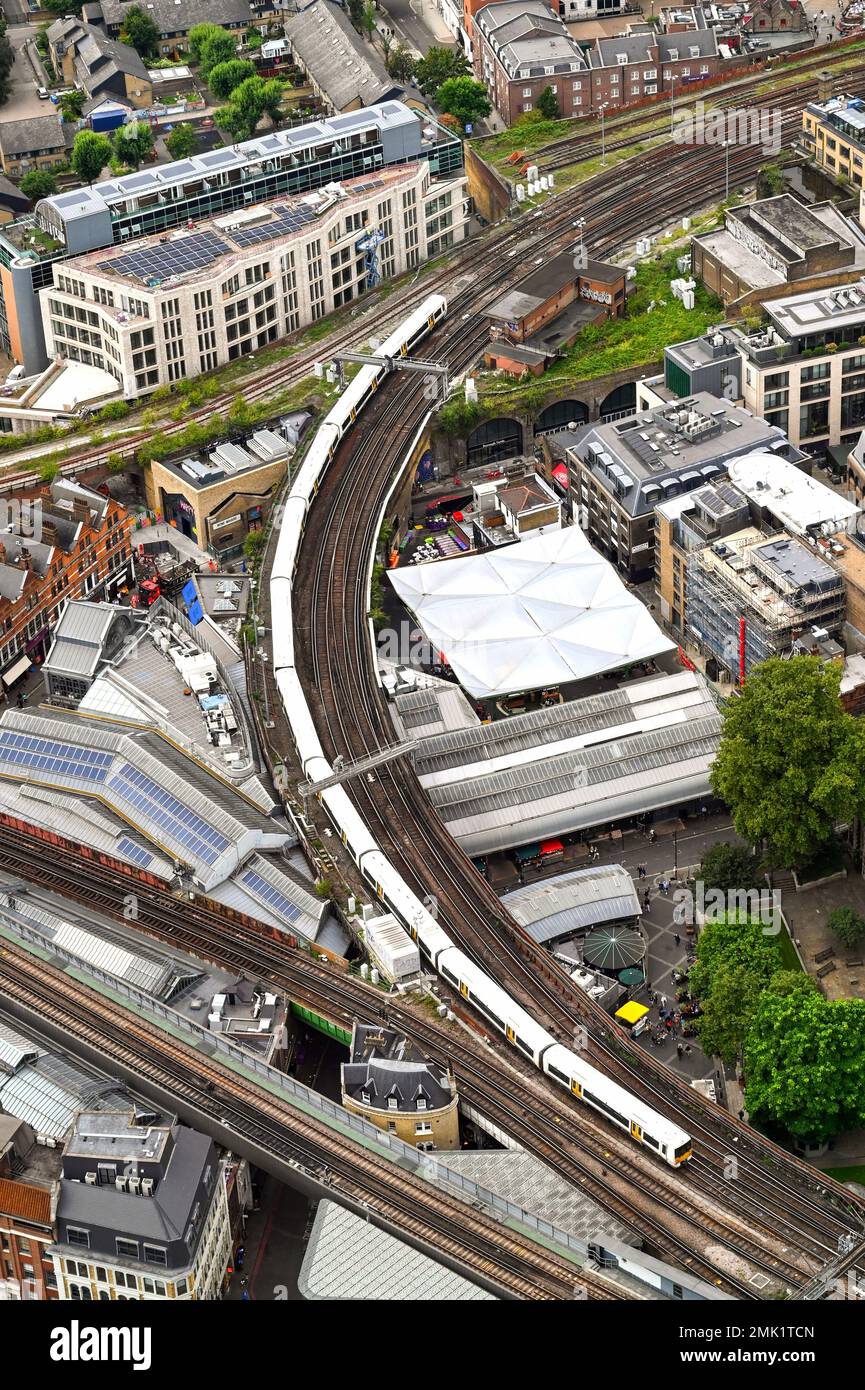 London, UK - August 2022: Aerial view of a commuter train running on ...