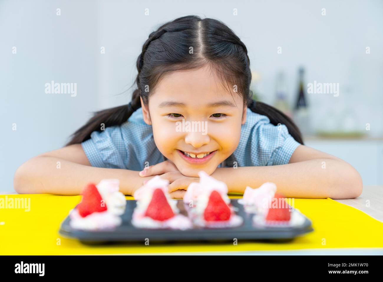 Happy little girl making cakes Stock Photo - Alamy