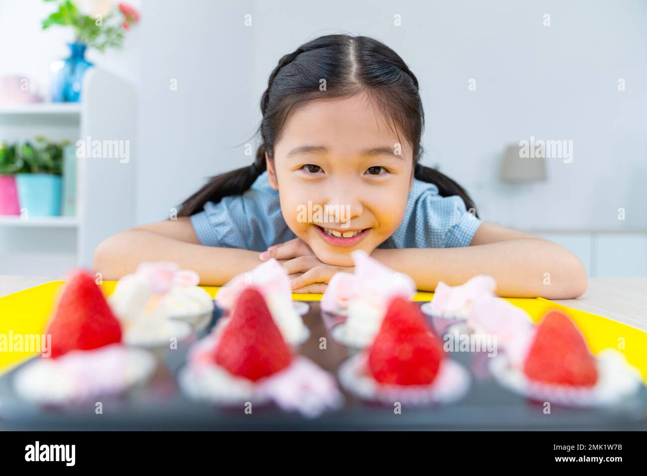 Happy little girl making cakes Stock Photo - Alamy