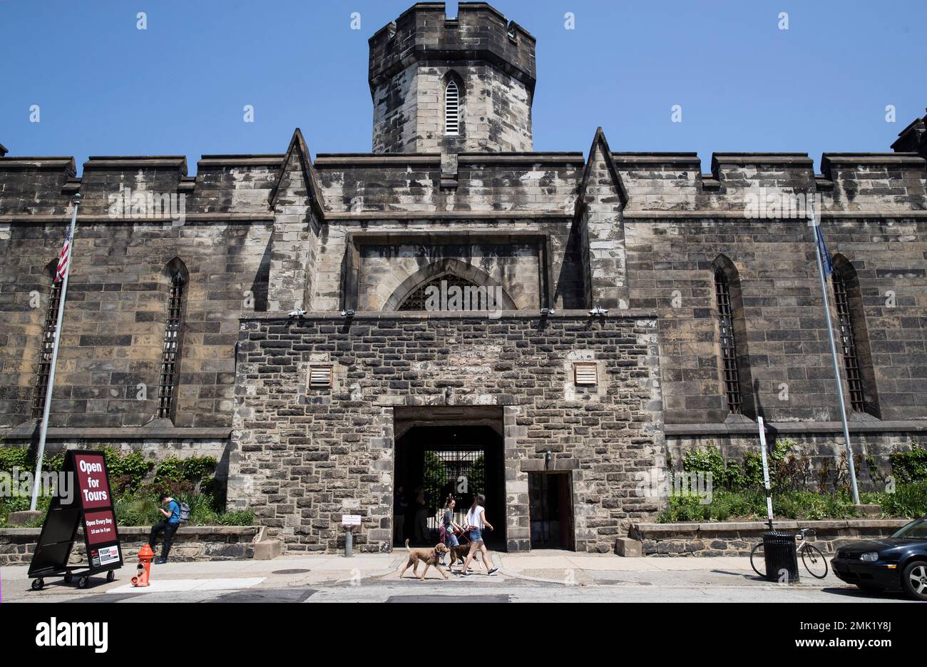 People walk past the Eastern State Penitentiary, Thursday, May 2, 2019 ...