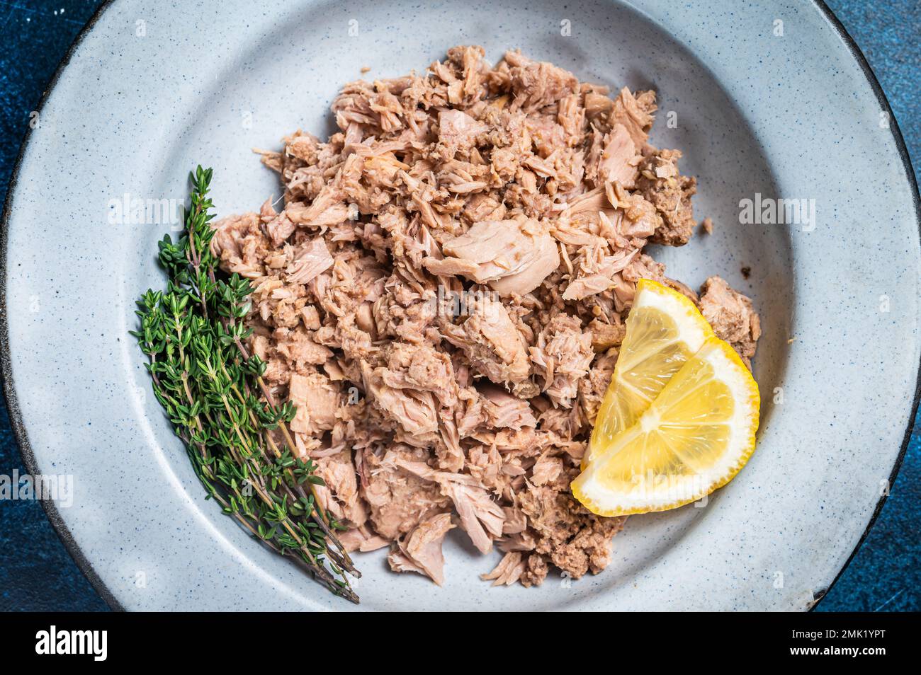 Canned Tuna chunks in olive oil ready for eat. Blue background. Top ...