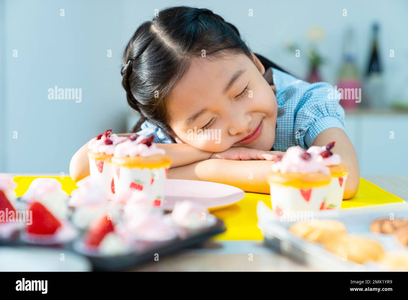 Happy little girl making cakes Stock Photo - Alamy