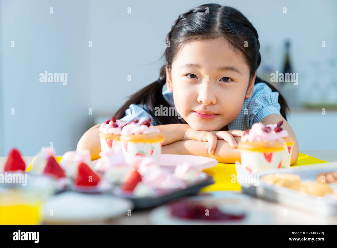 Happy little girl making cakes Stock Photo - Alamy