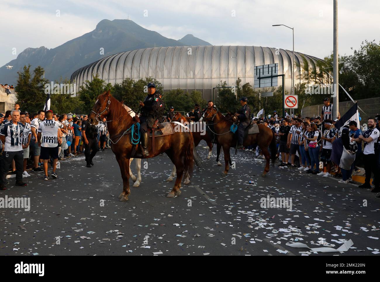 Police on horseback keep order as Monterrey fans wait to greet the team ...