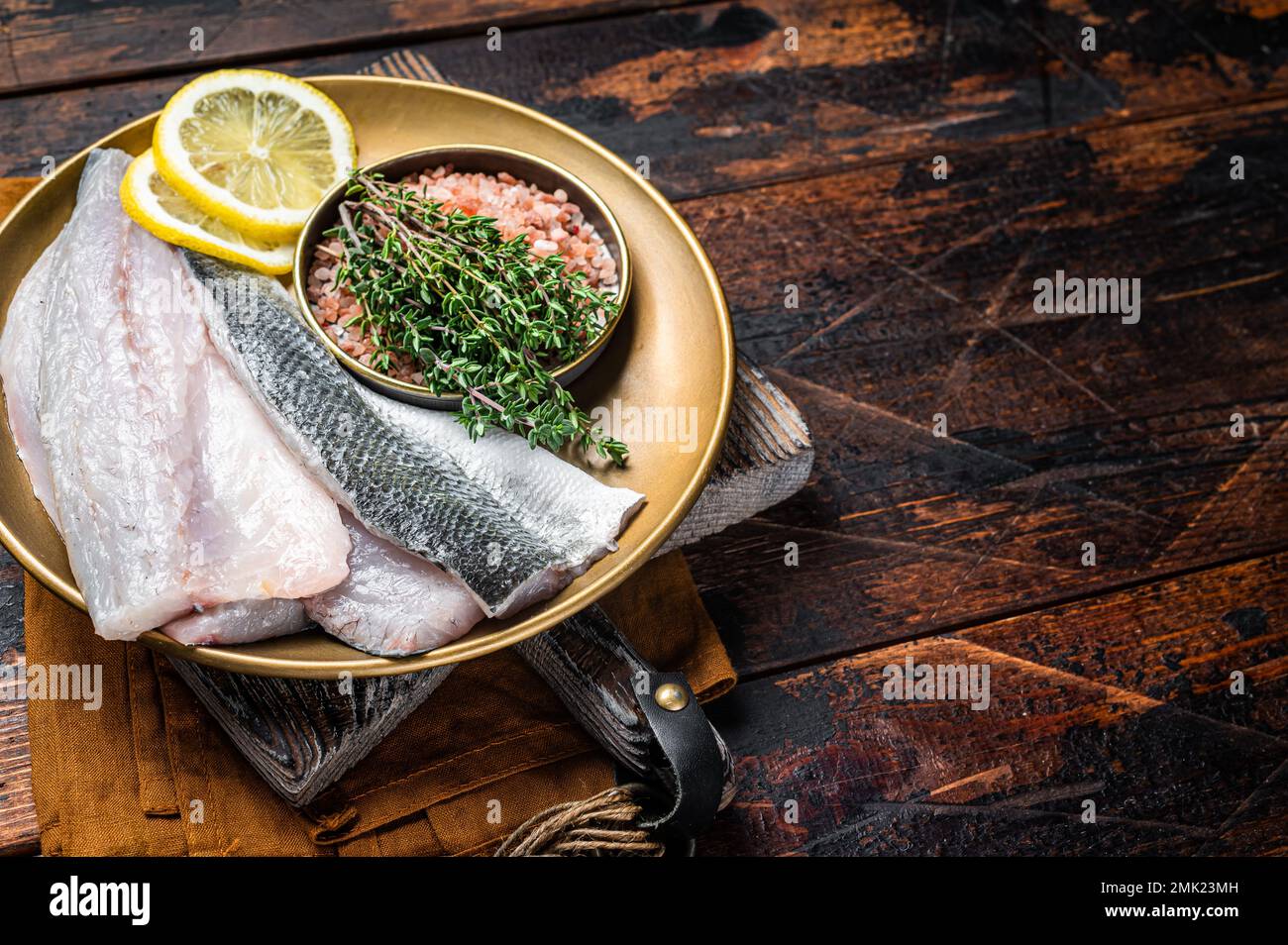 Uncooked Raw Sea Bass fillets, Seabass fish with thyme, pink salt and ...