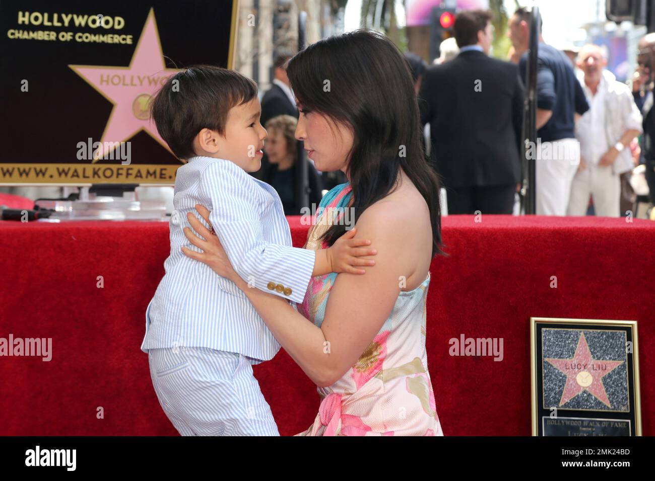 Lucy Liu, left, holds her son Rockwell Lloyd Liu following a ceremony ...