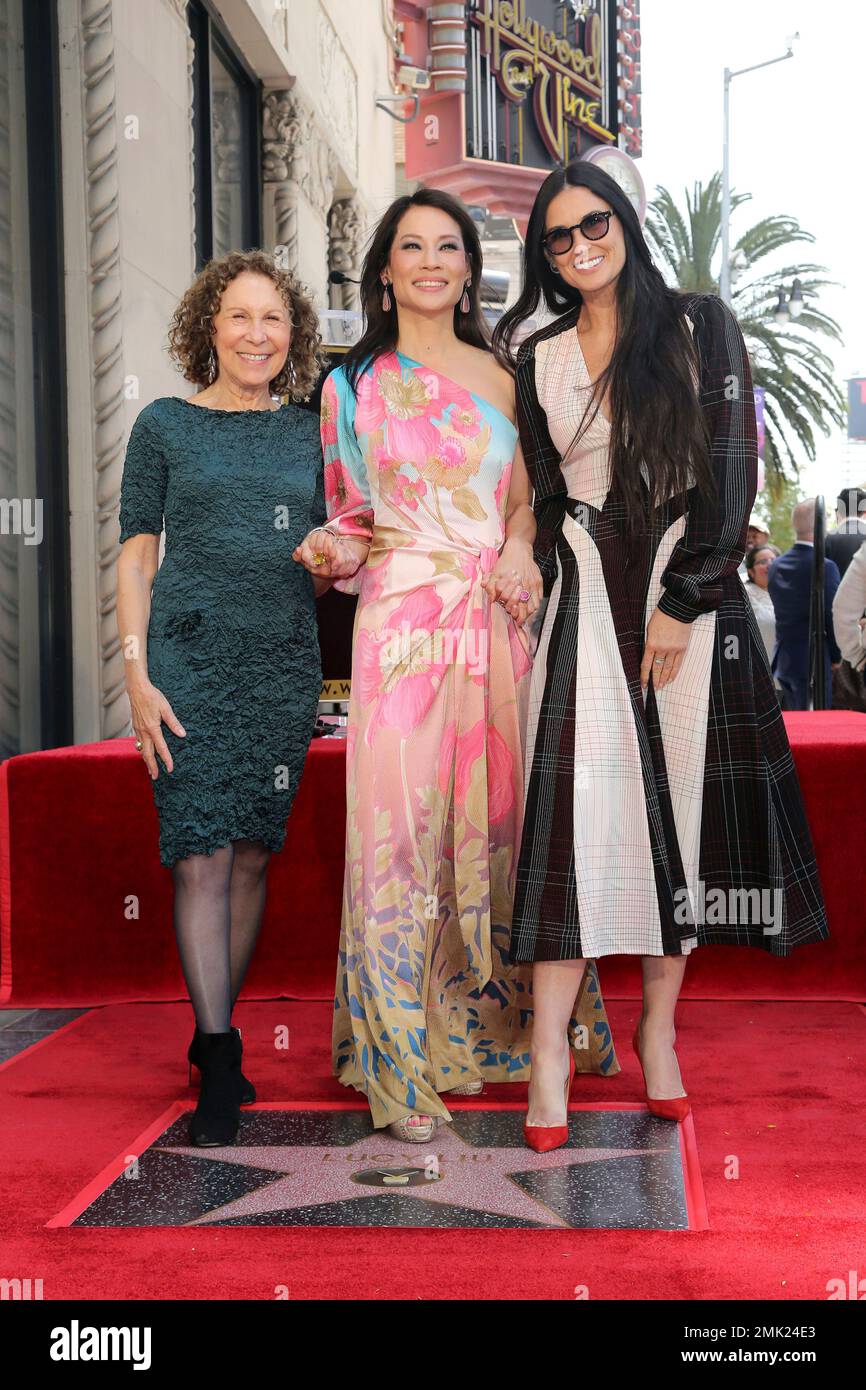 Rhea Perlman, from left, Lucy Liu and Demi Moore pose atop the star at ...