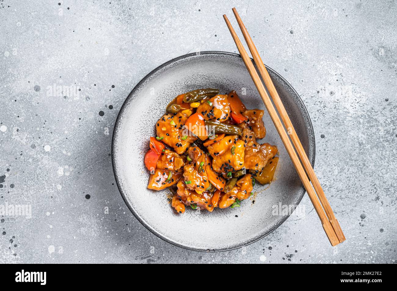 Chinese Sweet and Sour Pork guo bao rou in a bowl. Gray background. Top ...