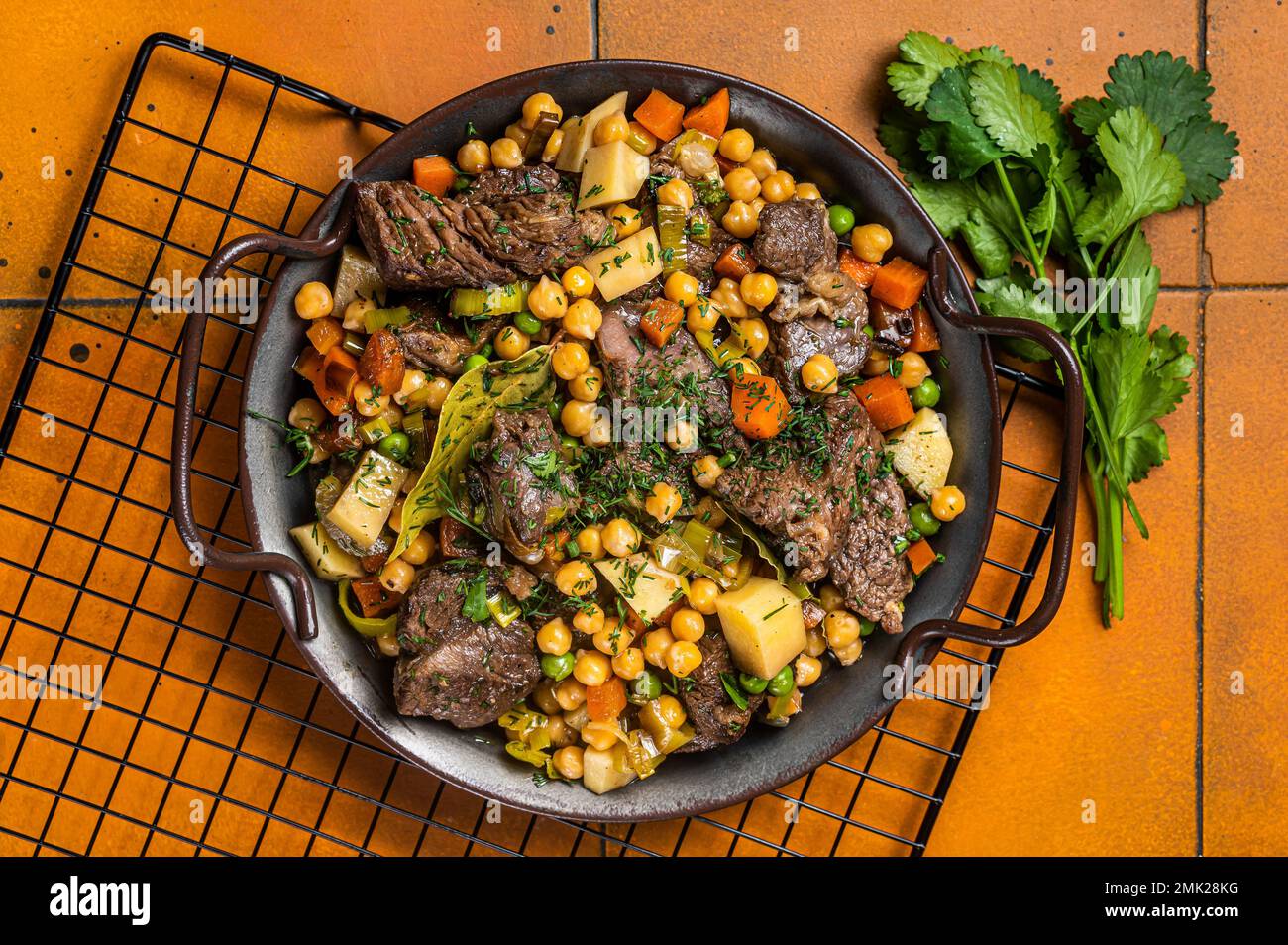 Spanish cocido Madrid stew with chickpeas, meat, carrots and potatoes ...