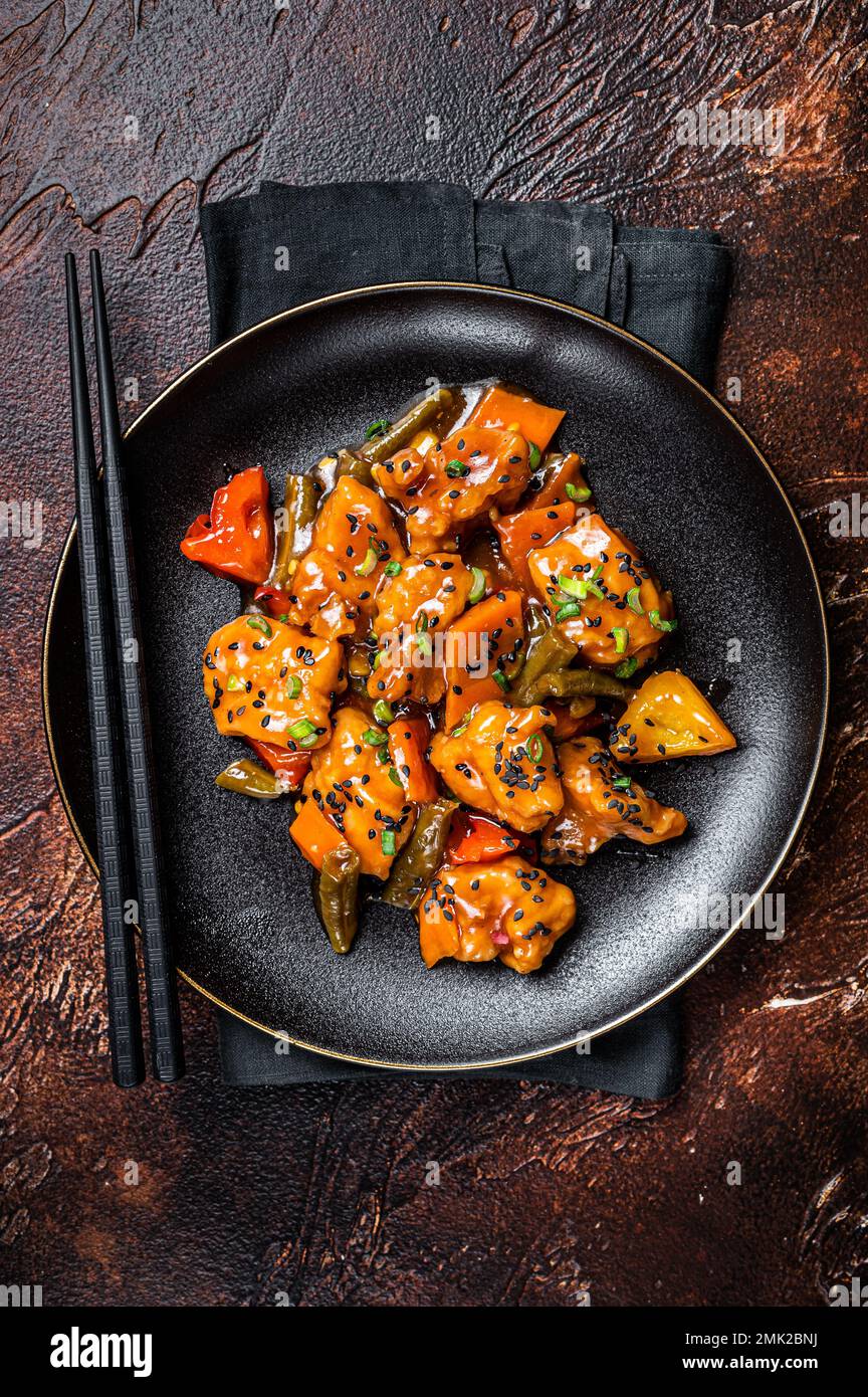 Chinese cuisine sweet and sour pork guo bao rou. Dark background. Top ...