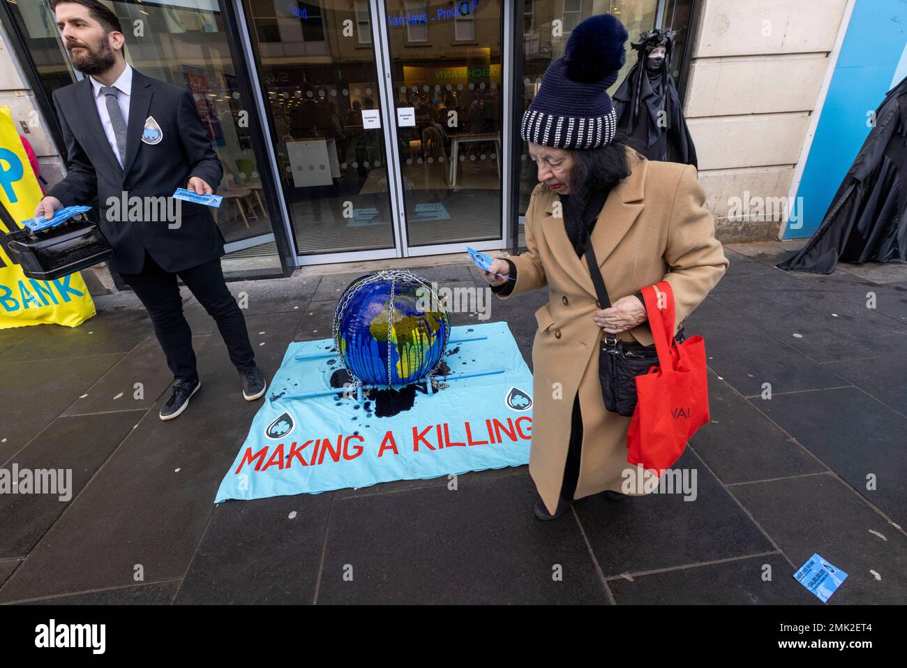 Extinction Rebellion Scotland activists, dressed as Barclays executives ...