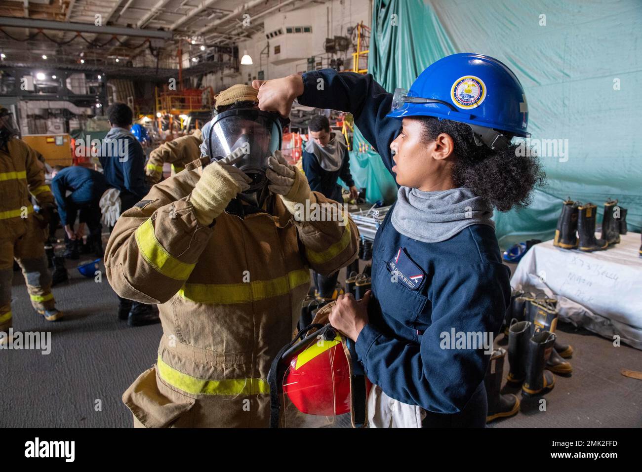 Information Systems Technician Jada Chepkwurui assists in the donning ...