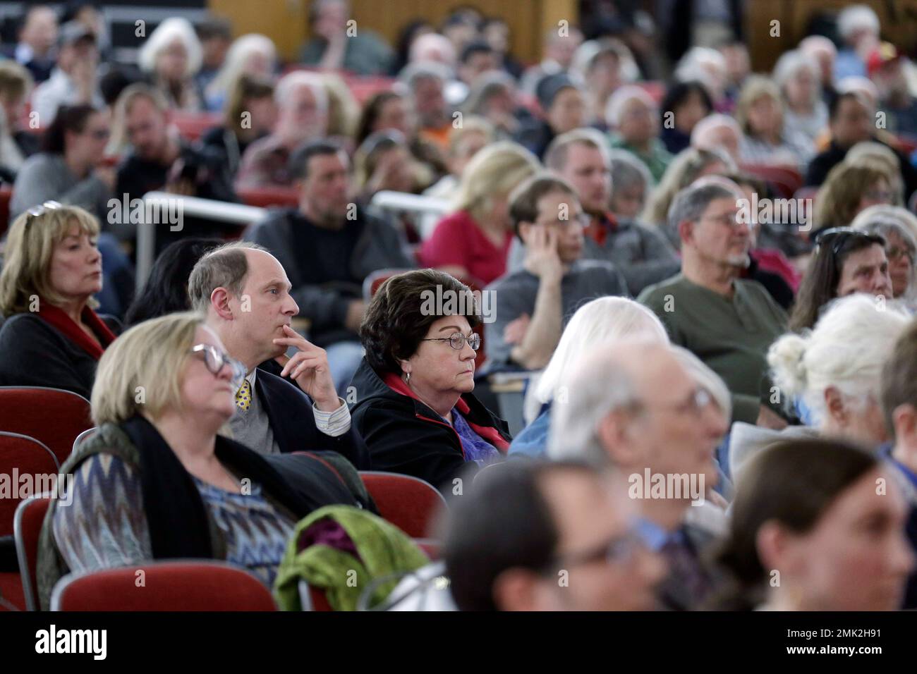 People listen to speakers during a planning board meeting regarding ...
