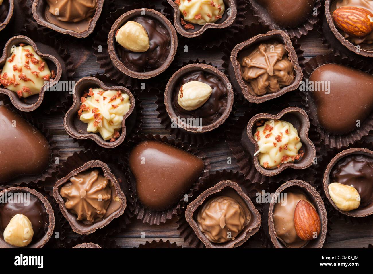 Different kinds of chocolates on colored table close-up. Top View and ...