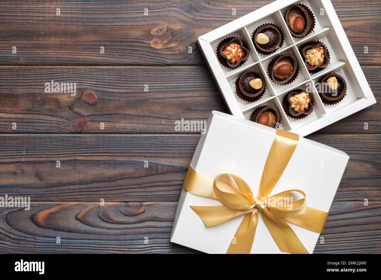 White box with chocolates candies and golden tape. top view with copy ...