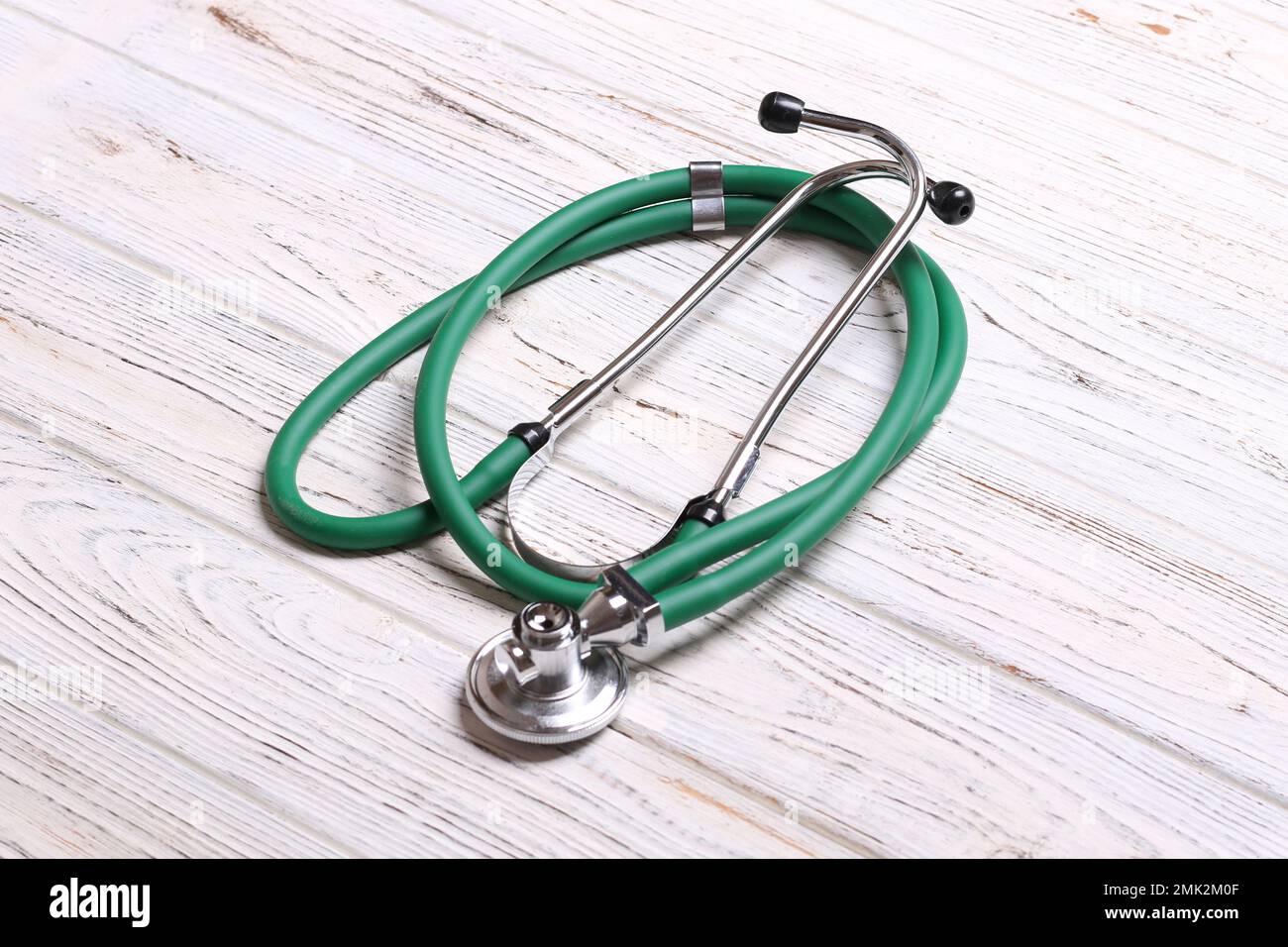 Top view of green stethoscope on wooden background. Medical examination ...