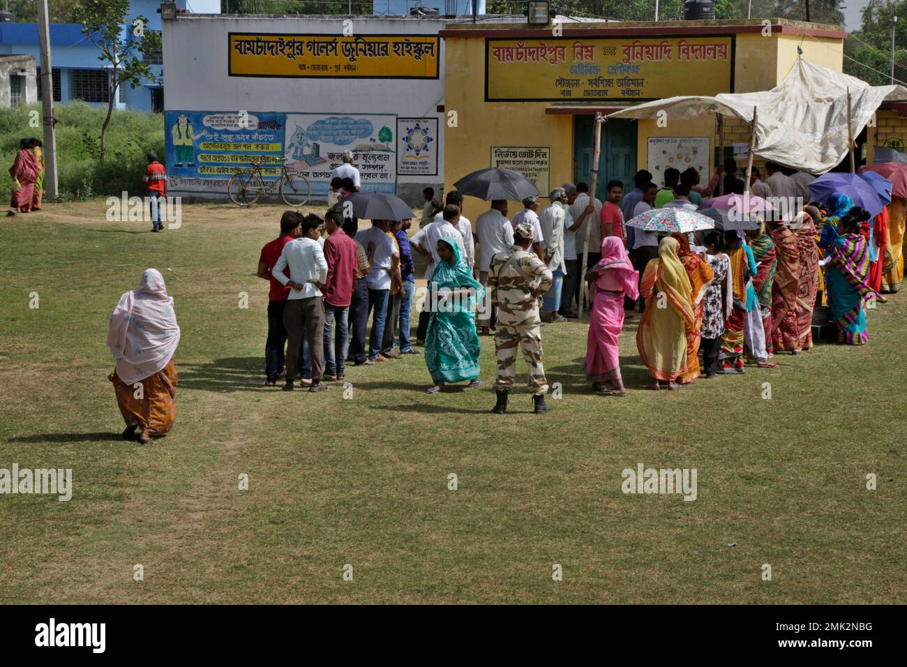 Indian voters stand in queue to cast their votes at a polling booth in ...