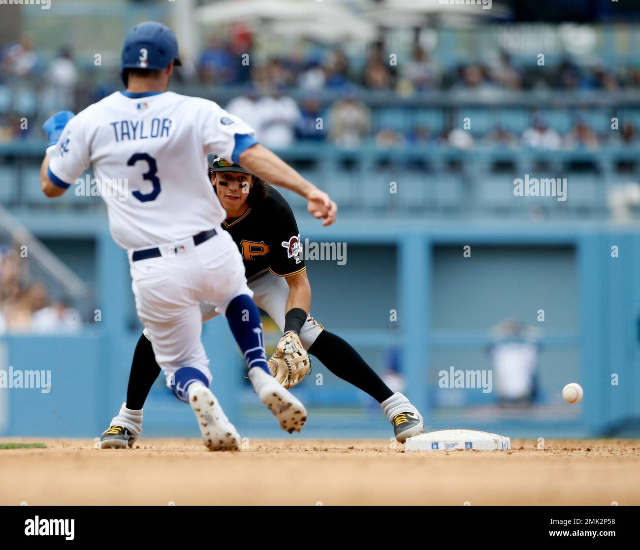 Pittsburgh Pirates shortstop Cole Tucker, right, looks for the ball as ...