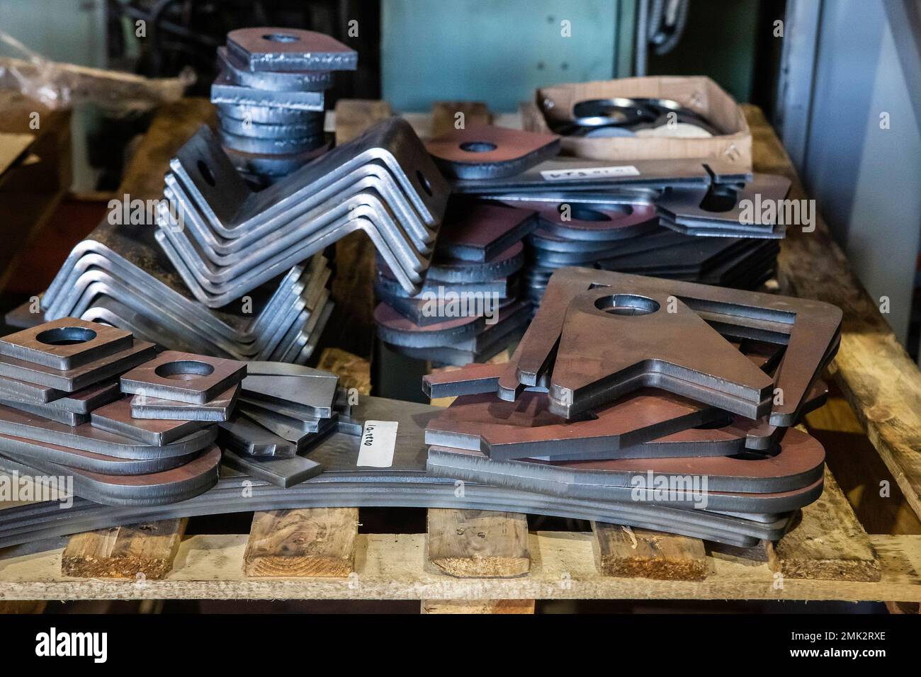 Laser cut iron parts in factory warehouse Stock Photo - Alamy