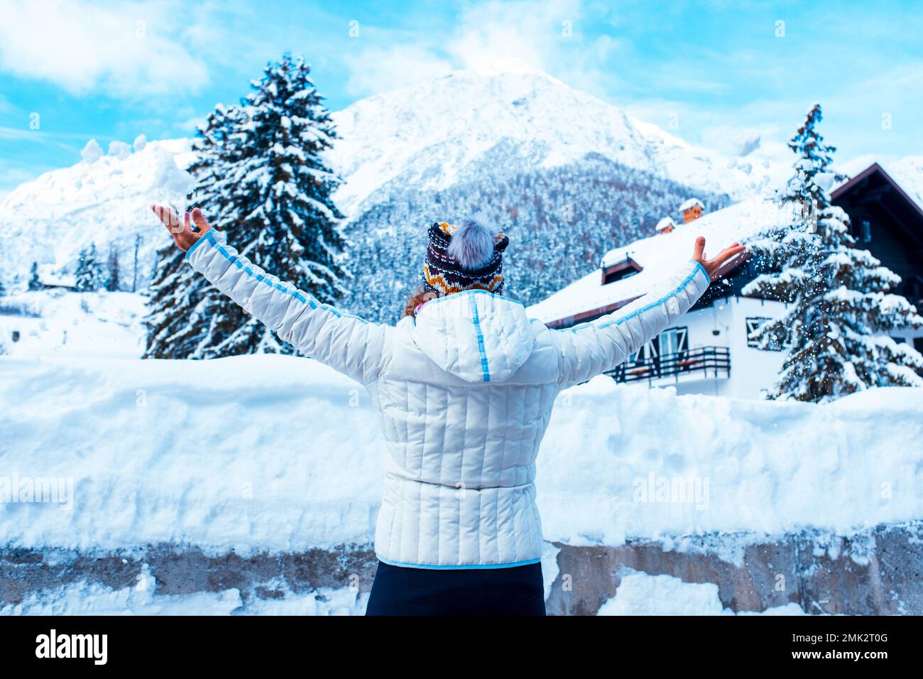 Back view of tourist woman enjoying winter snow landscape mountains and ...