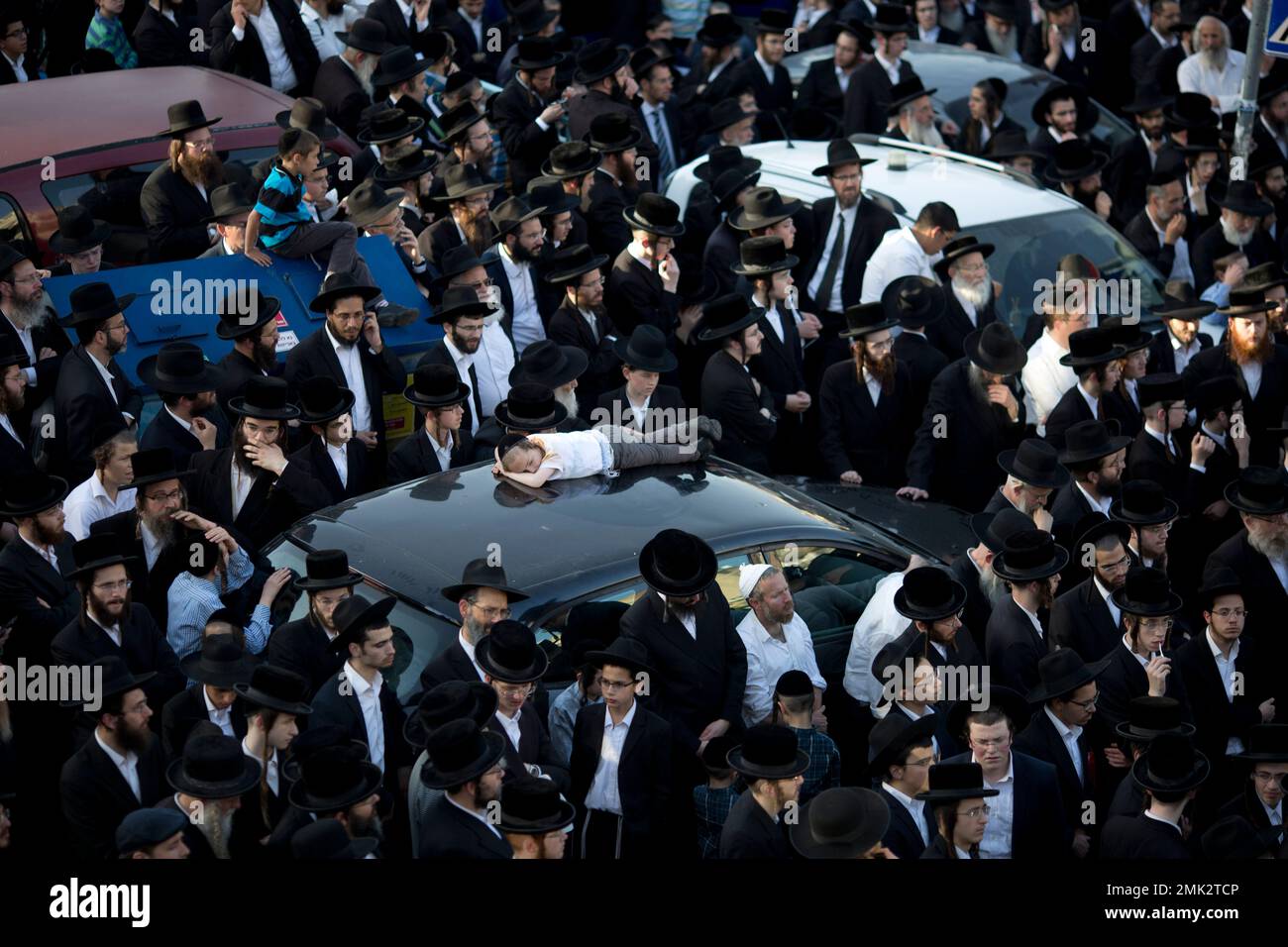 Ultra-Orthodox Jews watch the funeral procession of Rabbi of the Kaliv ...