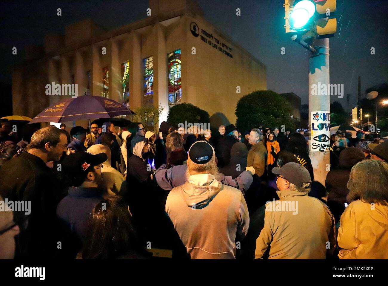 A group gathers outside the Tree of Life Synagogue for a vigil to honor ...