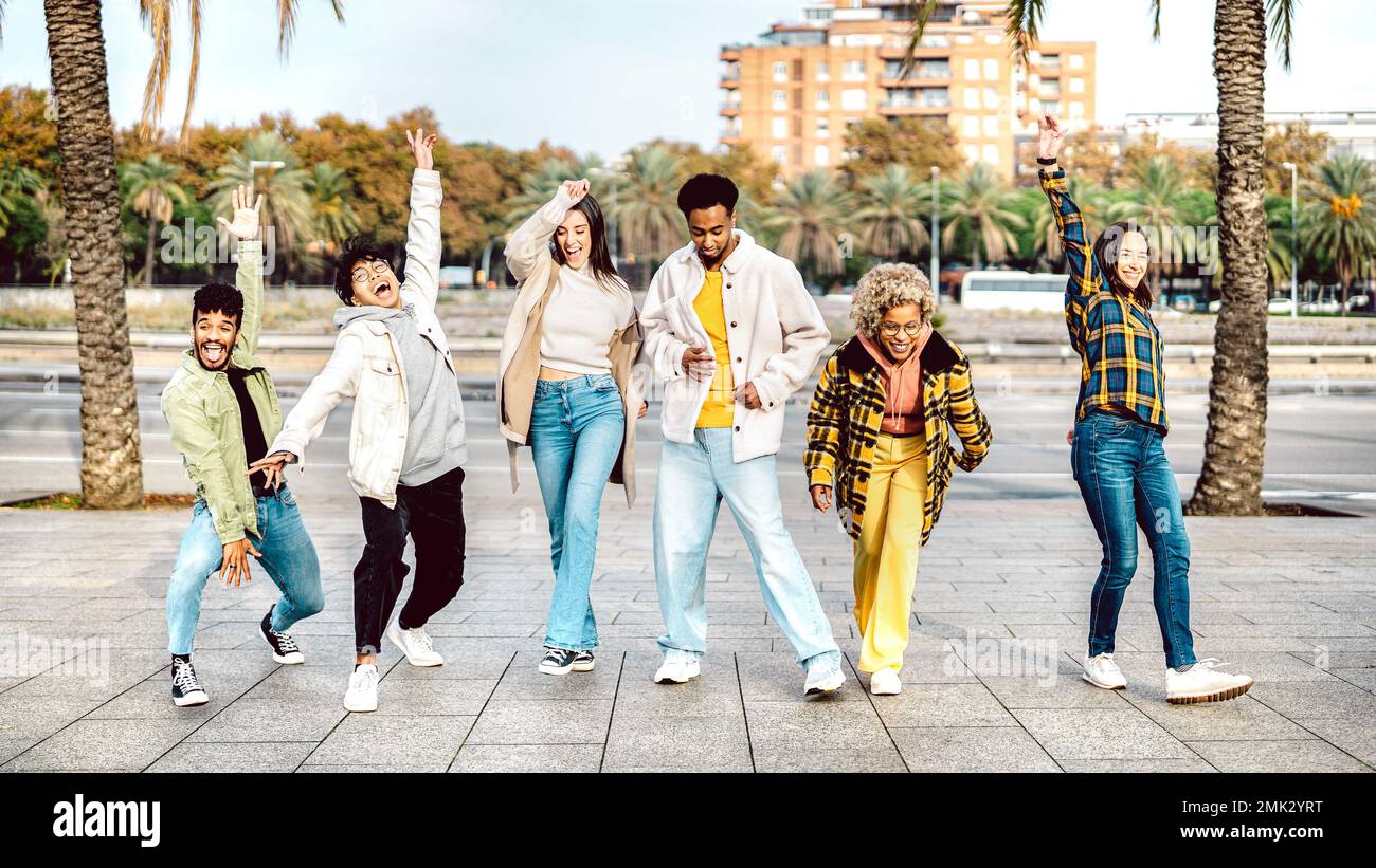 Multicultural friends walking at Barcelona boardwalk on funny mood ...