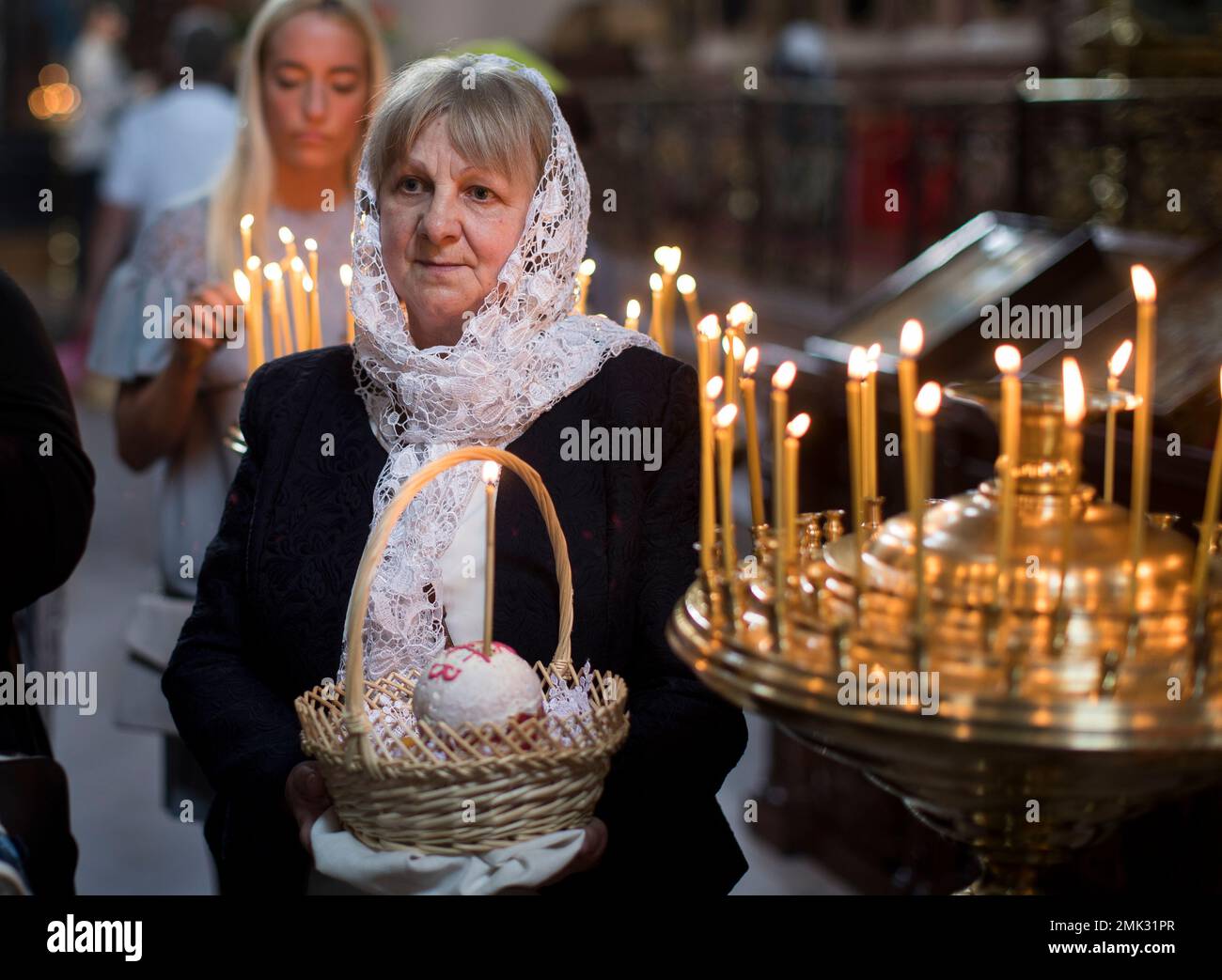 Believers wait for a Lithuanian Orthodox priest to bless their ...