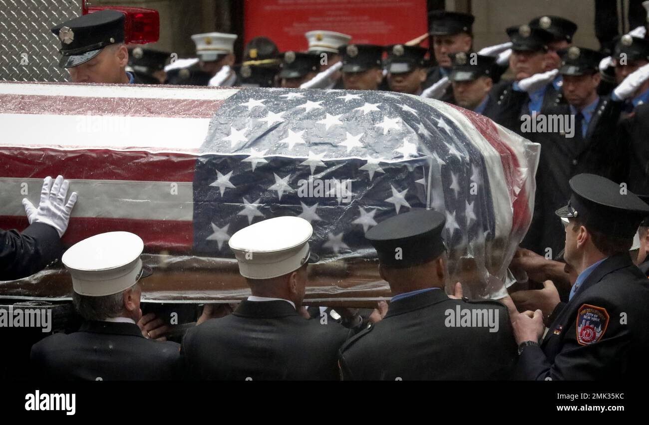 Firefighters hoist the casket of U.S. Marine Corps Staff Sergeant and ...